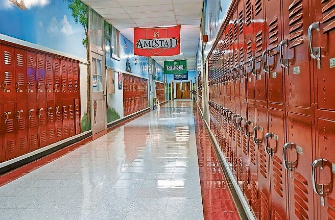 IAN GRENIER/STAFF Lockers line the hallways of Brennen Elementary ...