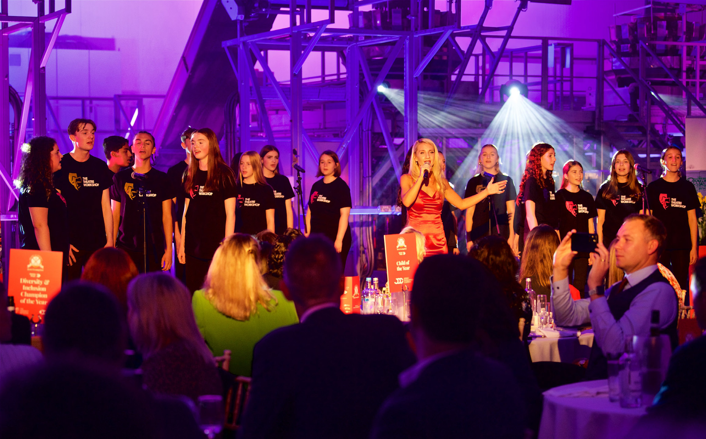 •Co-host Georgi Mottram sings with young people from The Theatre ...