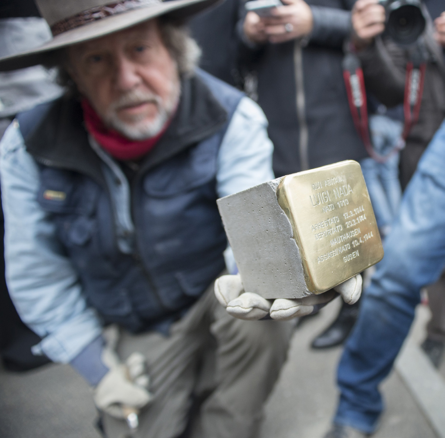 gunter demnig lays one of his stumbling stones in turin italy in 2016 ...