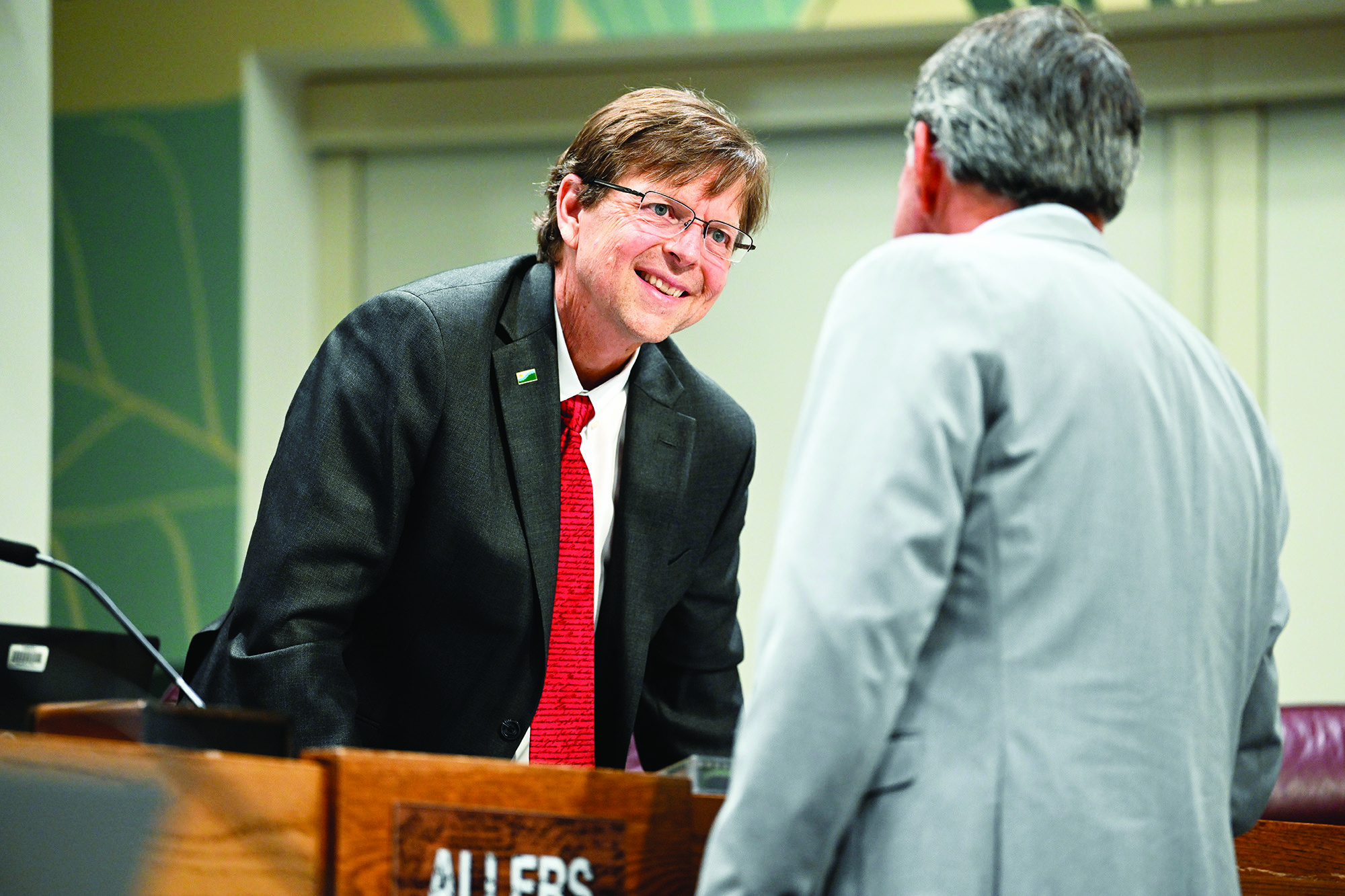 Spokane City Council President Breean Beggs, left, chats with a member ...