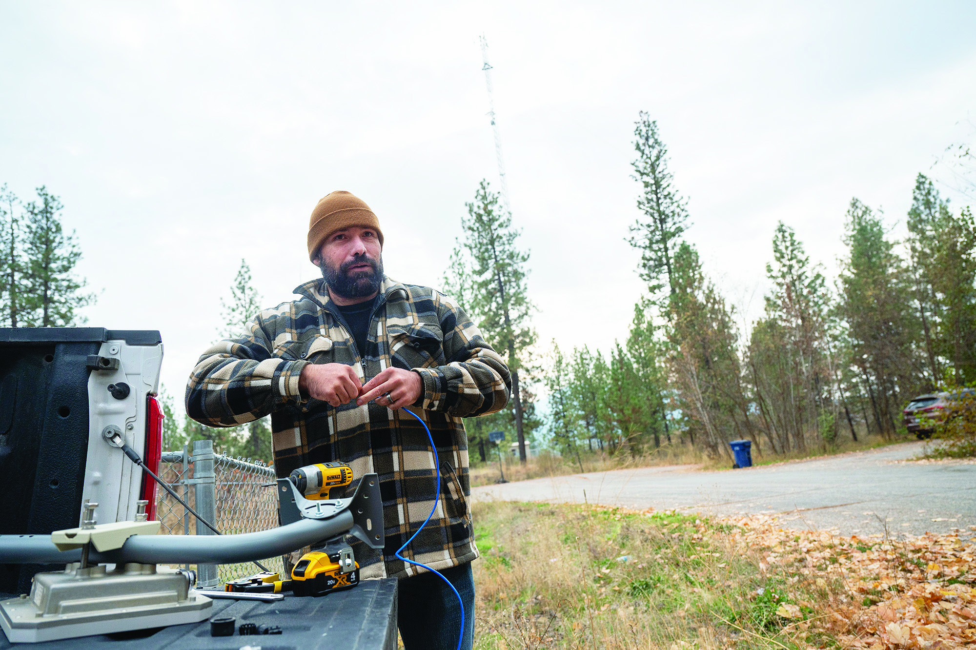 christopher carson of sp q n i broadband services prepares to install a ...