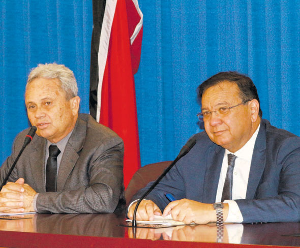 Finance Minister Colm Imbert, left, responds to a question while Energy ...